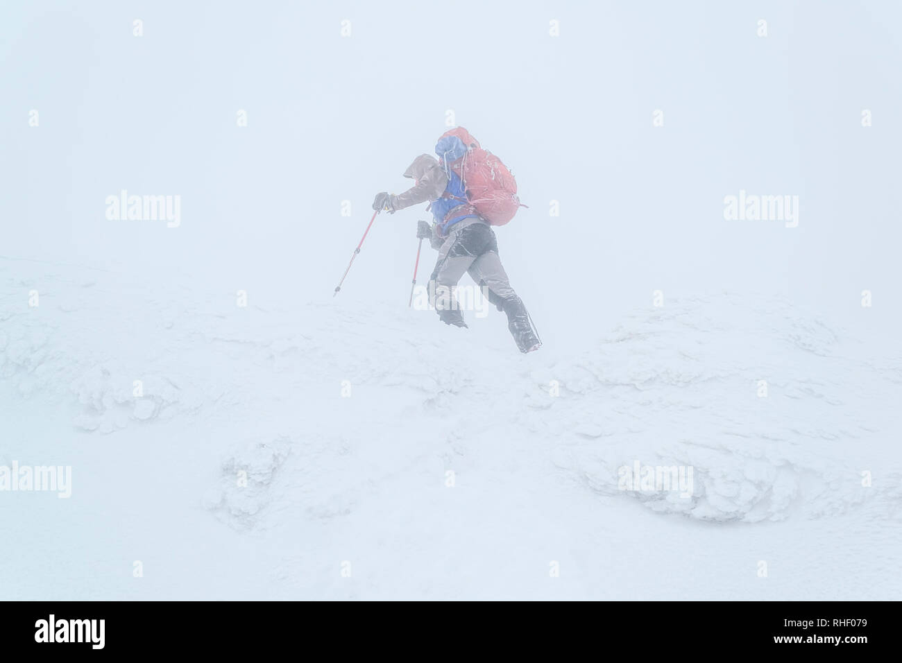 Tourist with a backpack hikes in fog. Winter. Bad weather. Cold ...