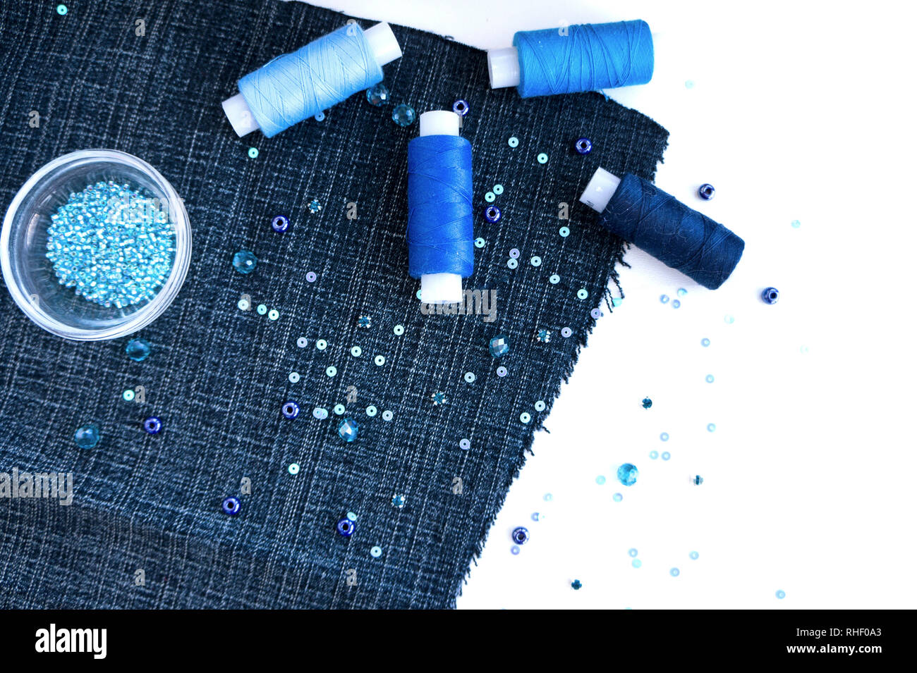 A set of materials for needlework in blue color on a white background ...