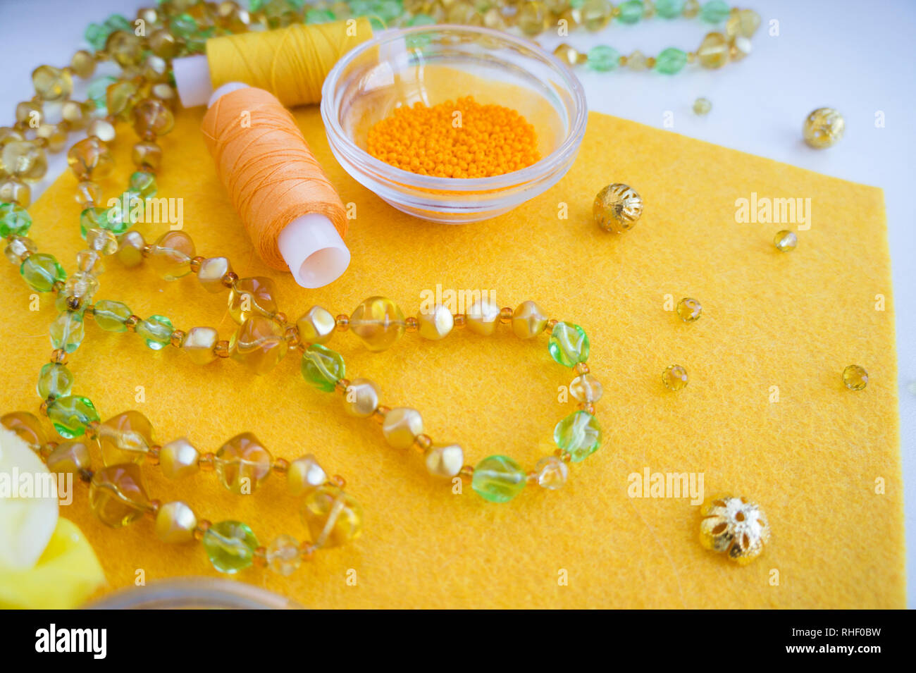 A set of materials for needlework in yellow color on a white background ...