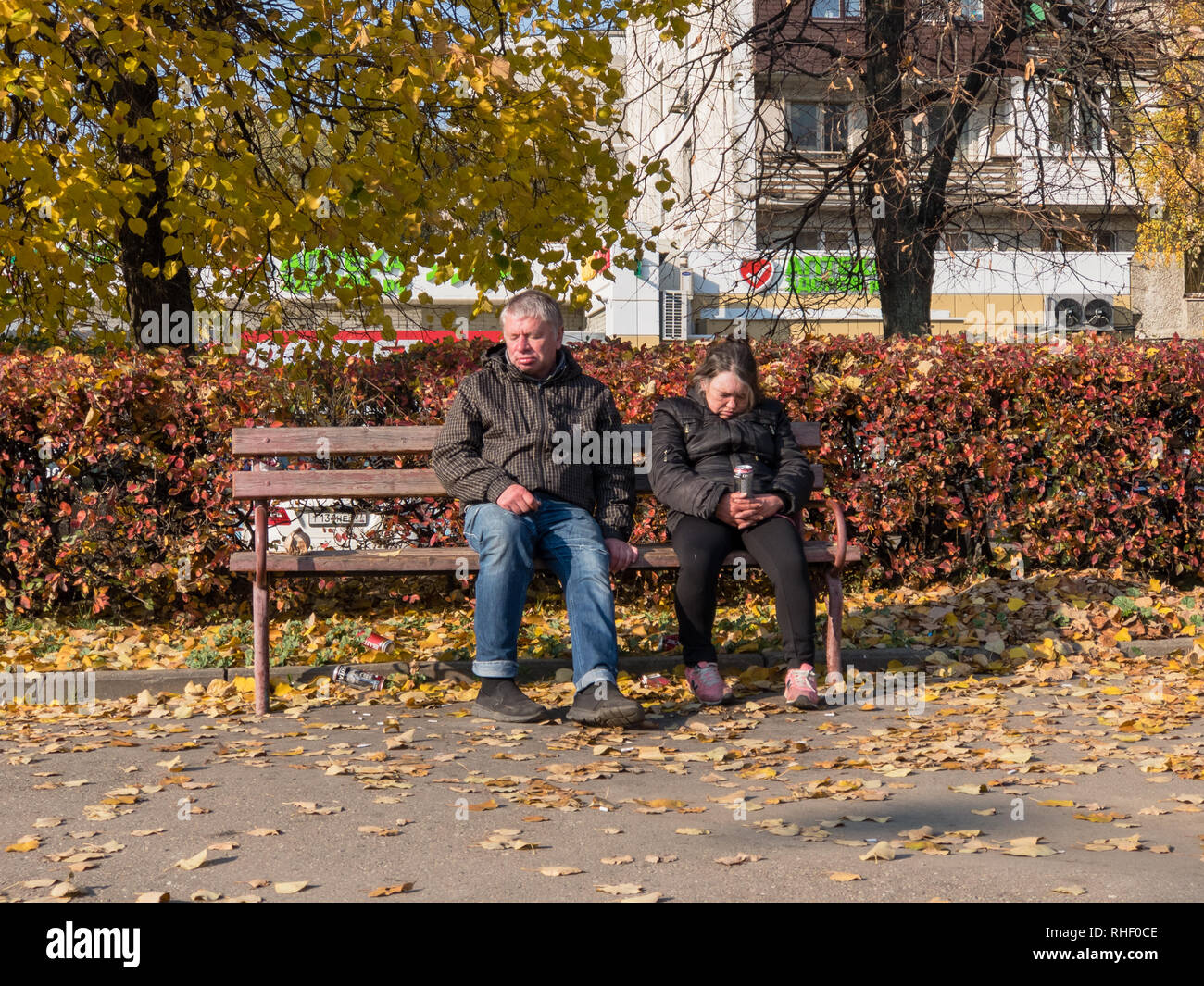 Drunk homeless couple sit on a bench near the subway Stock Photo - Alamy