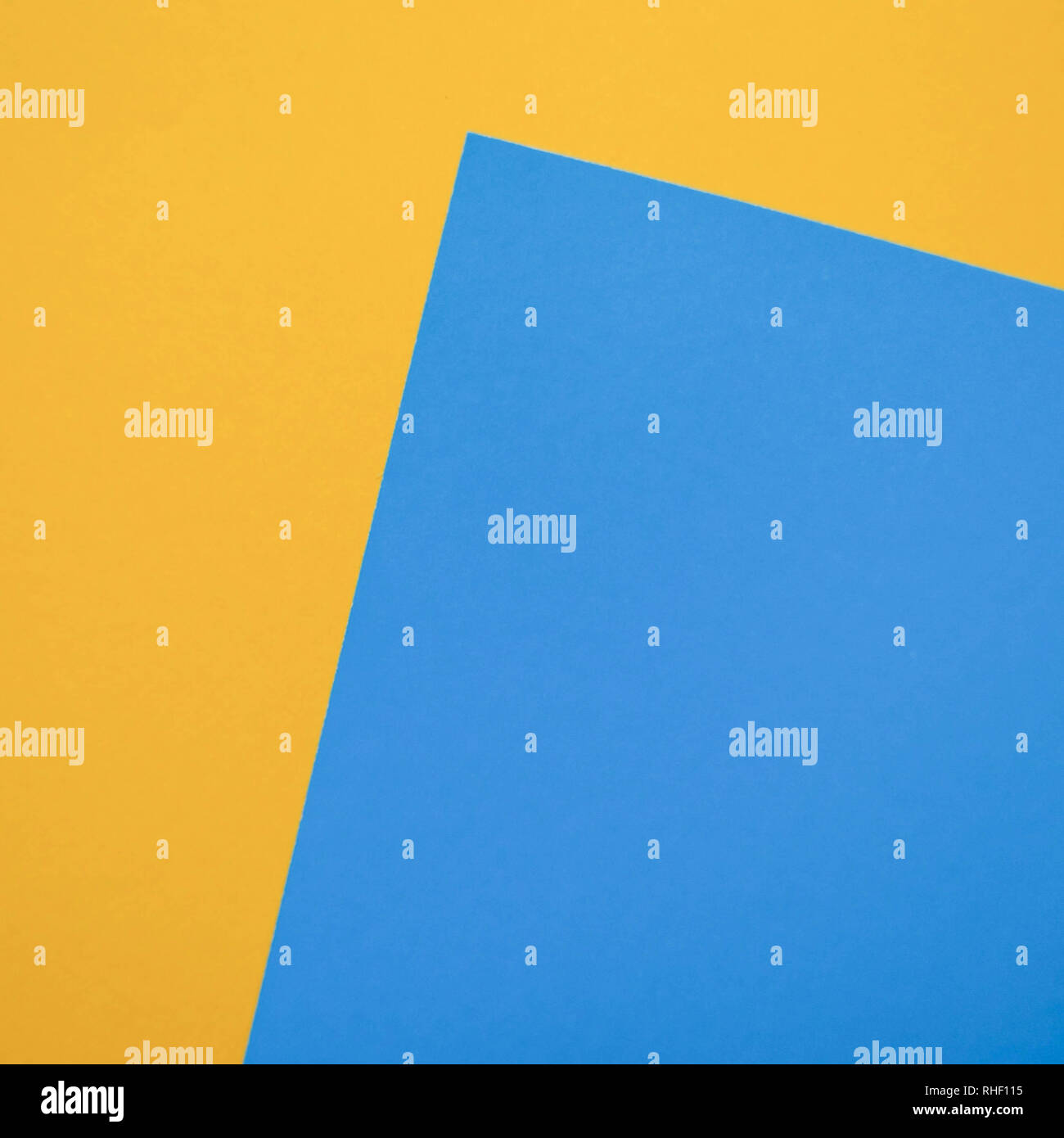 Lovely flat lay background with color paper sheets. Yellow and blue ...