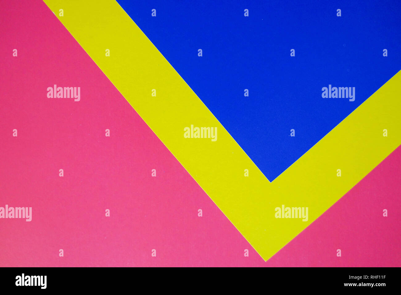 Lovely flat lay background with color paper sheets. Yellow, blue and ...