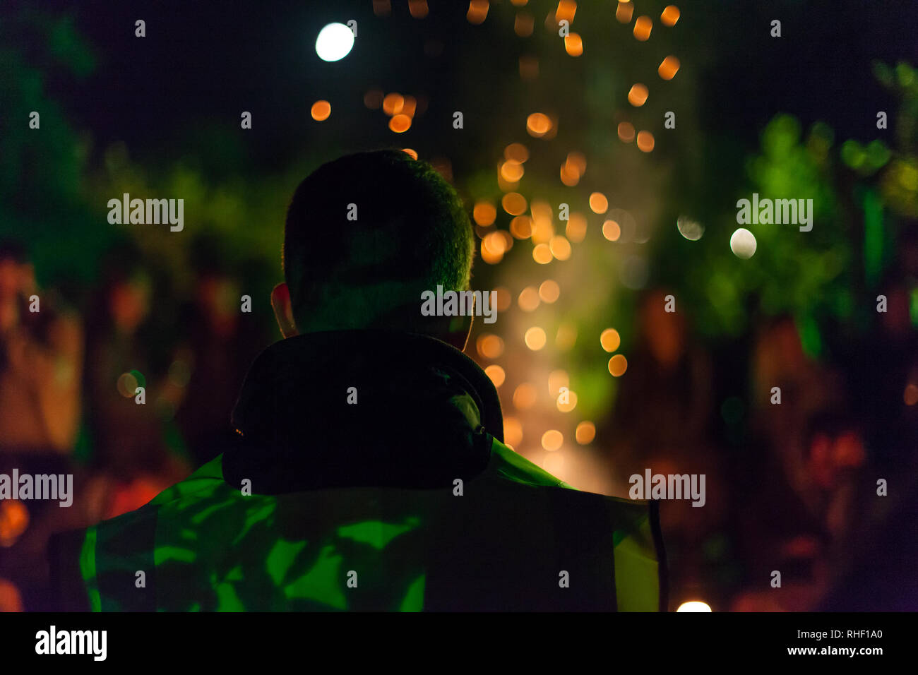A man gazing at a fire, with sparks in the background Stock Photo - Alamy