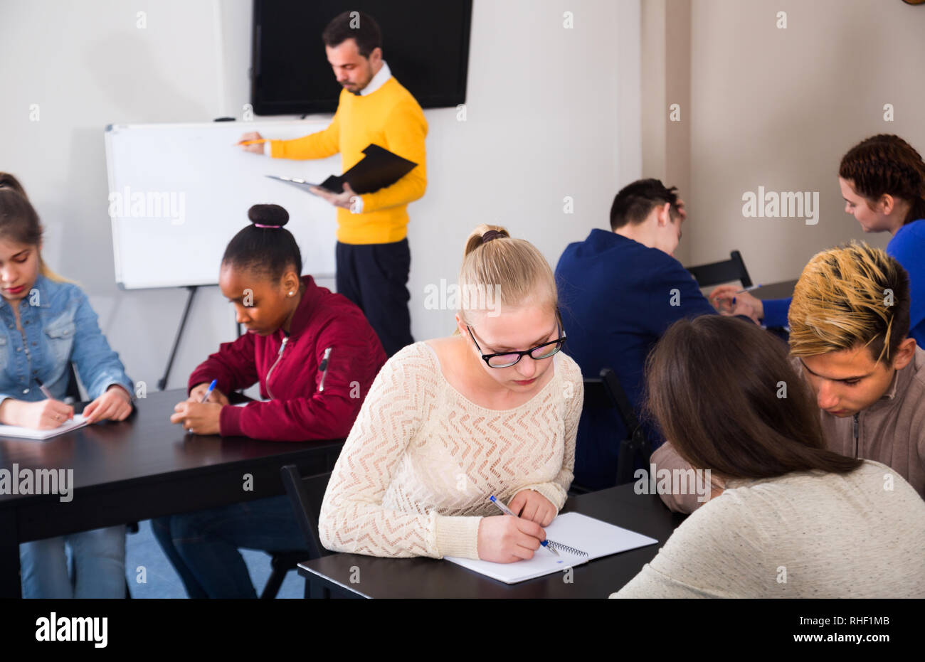 Female and male students are working in large groups in school Stock ...