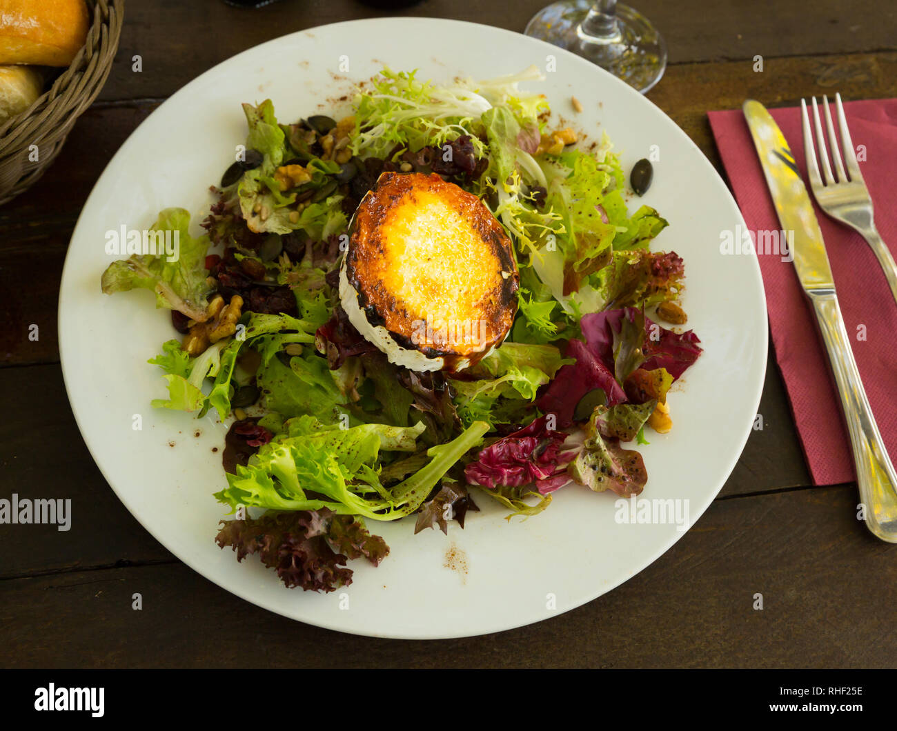 Warm goat cheese with lettuce, nuts and dried fruits salad Stock Photo ...