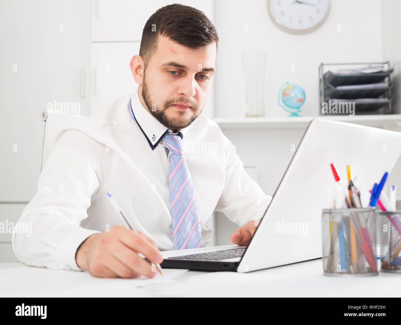 Smiling man worker working effectively on project in office Stock Photo ...