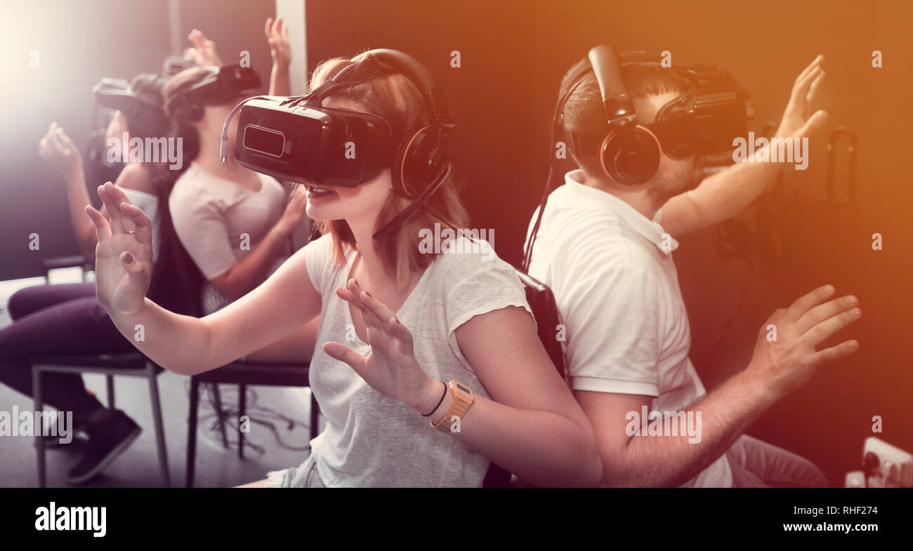 Young people having fun with a new technology of a vr headset goggles ...