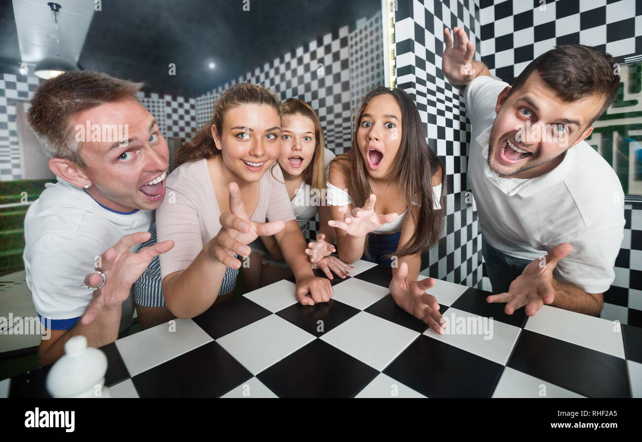 Group of young people having fun in an escape room stylized under ...