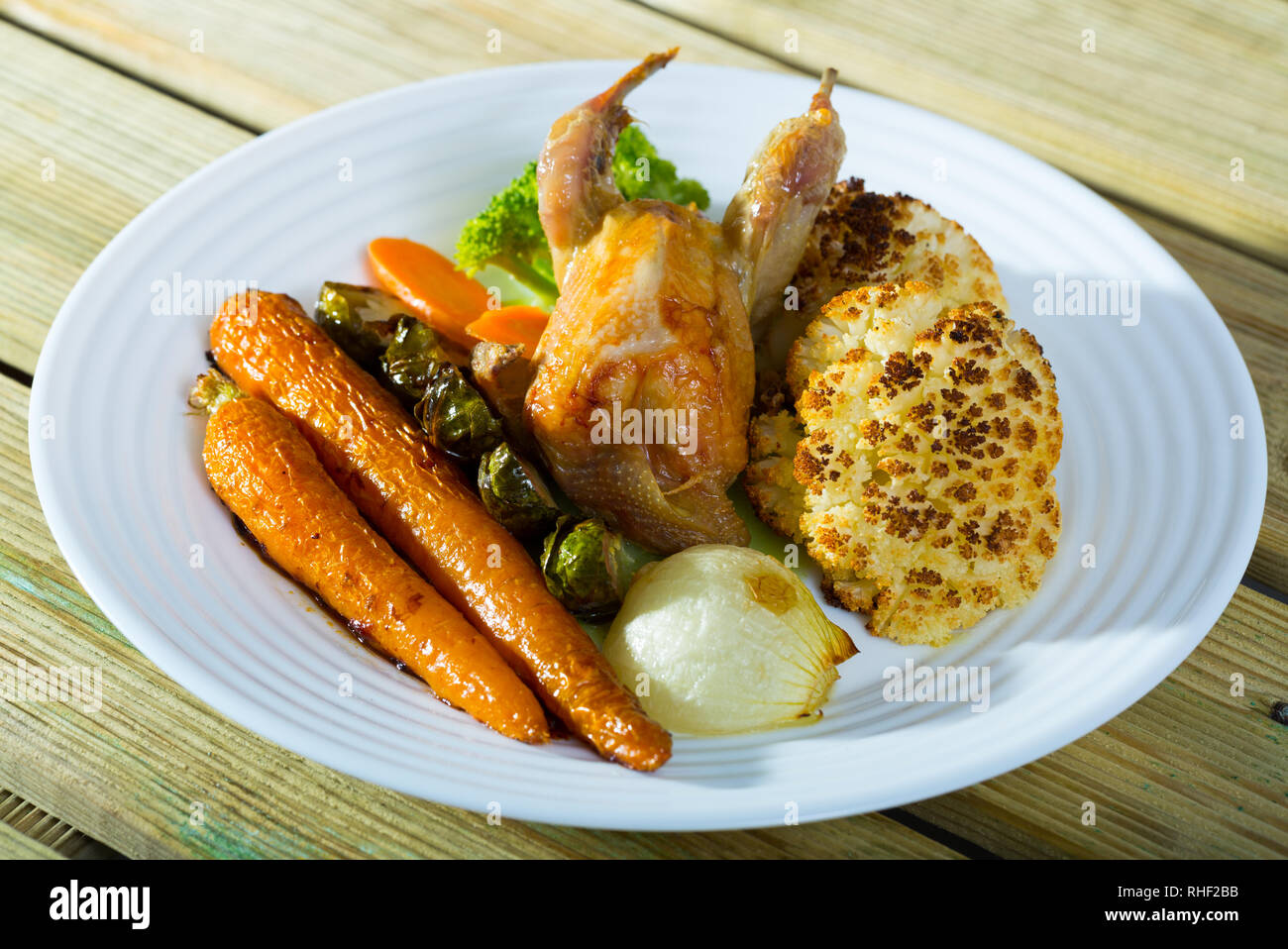 Image of plate with partridge baked with vegetables in honey-mustard ...