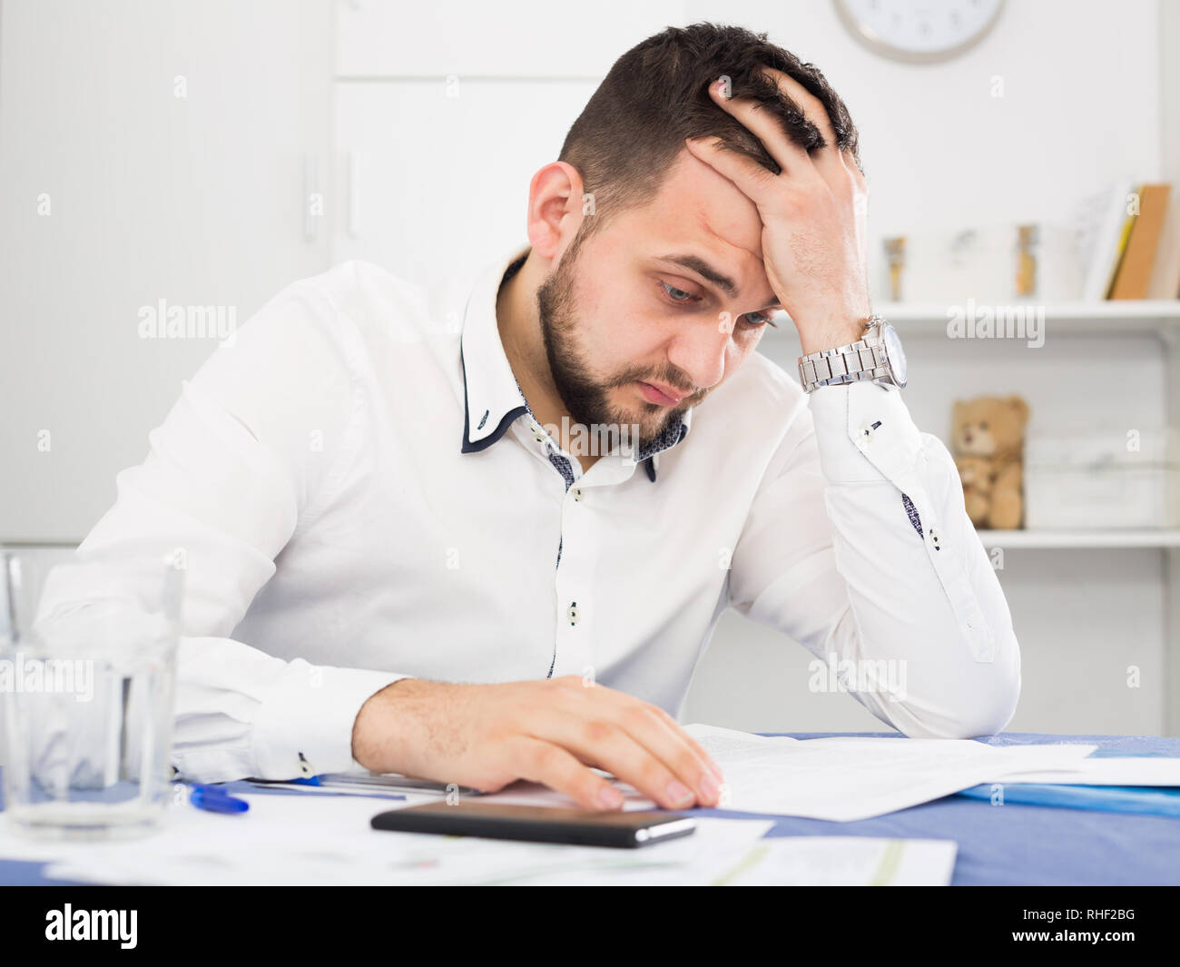 Distressed man having difficulties with paying utility bills and rent ...