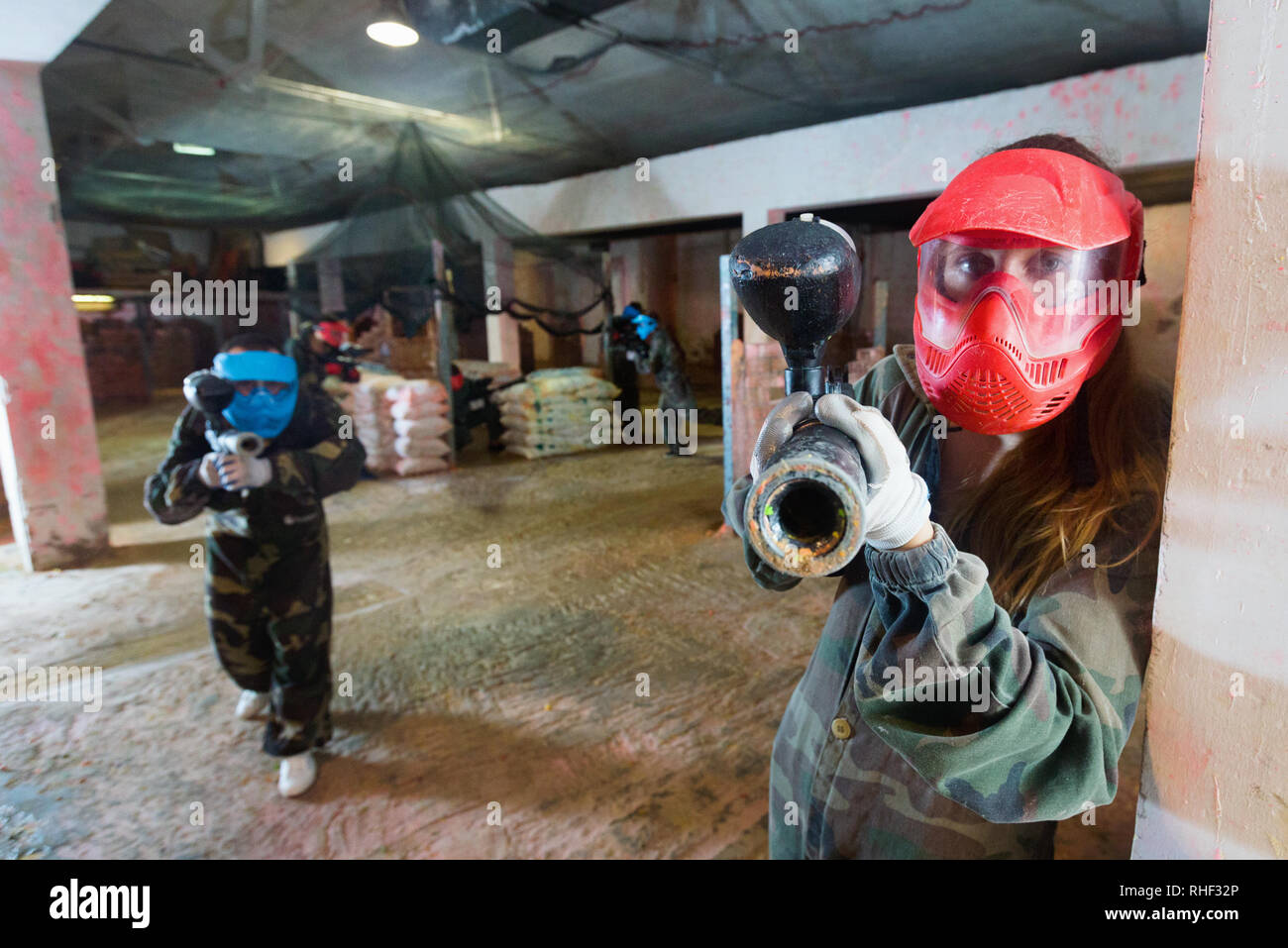 Portrait of red team happy positive player who is aiming in opponents ...