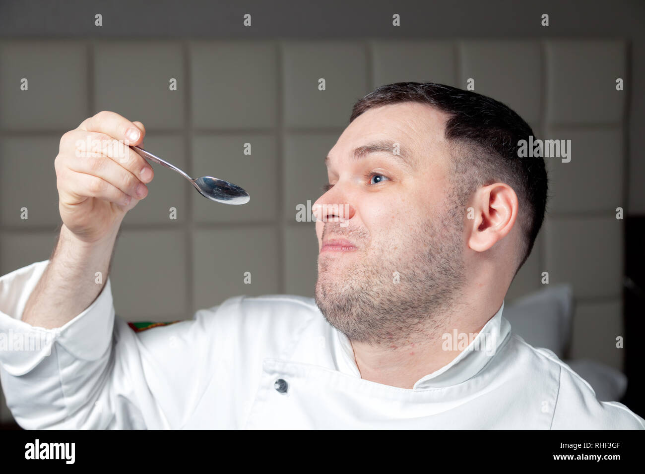 The chef tries the dish from the spoon. The concept of developing a new ...