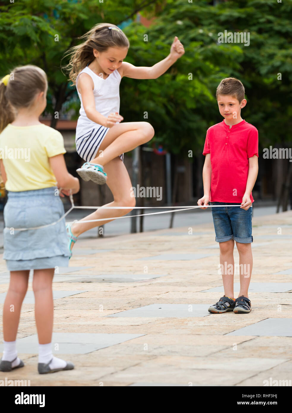 cheerful boy and girls in elementary school age playing with chinese ...