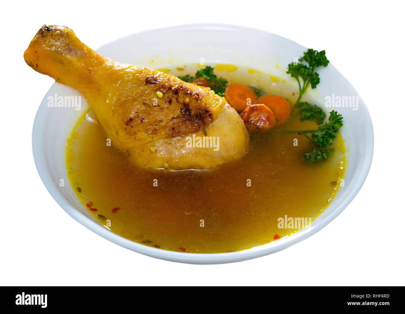 Bowl of homemade chicken bouillon with carrot and herbs and garlic ...