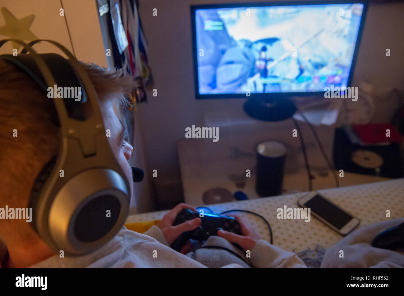 A teenaged boy playing computer games in his bedroom Stock Photo - Alamy