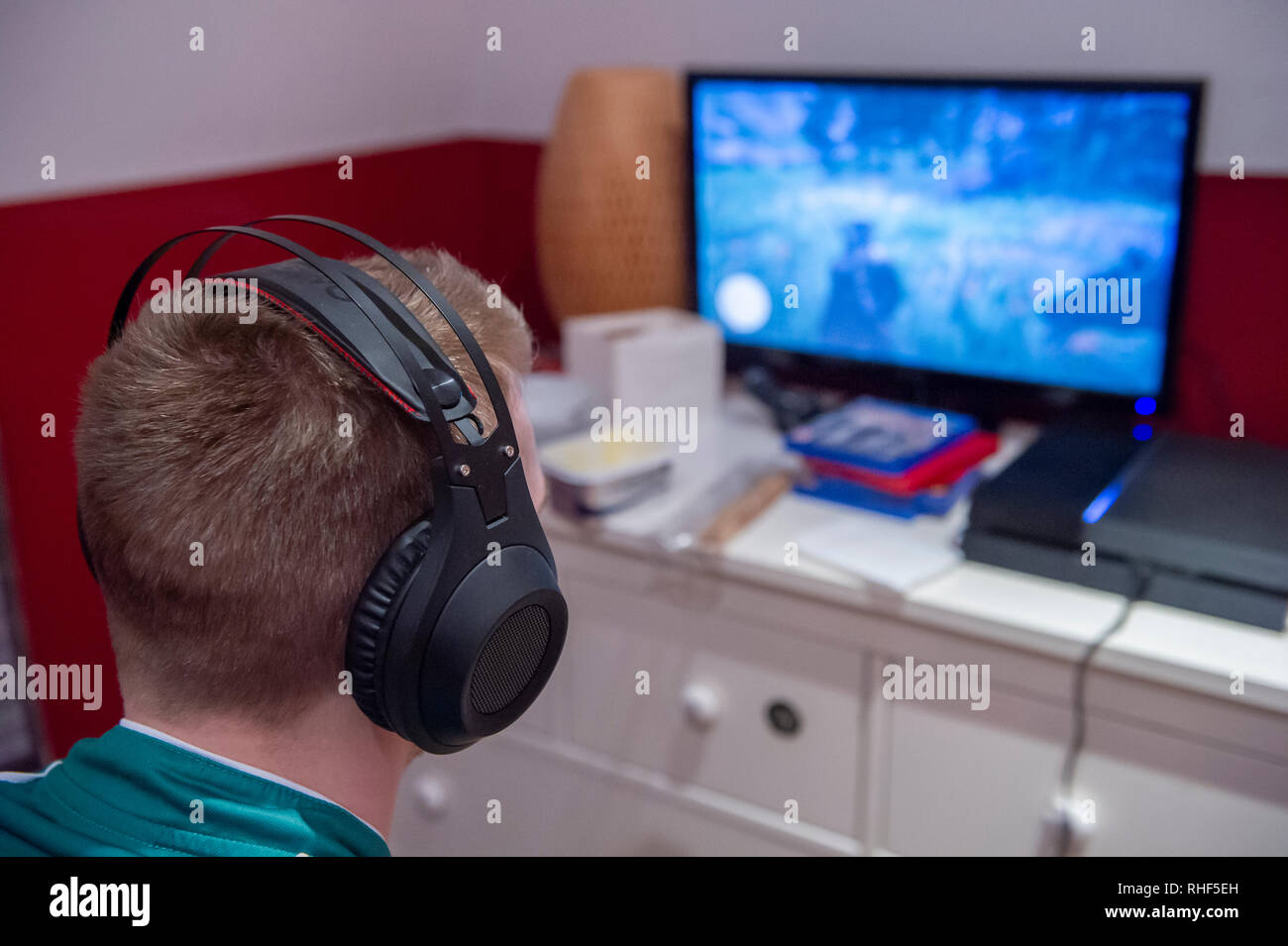 A teenaged boy playing computer games in his bedroom Stock Photo - Alamy