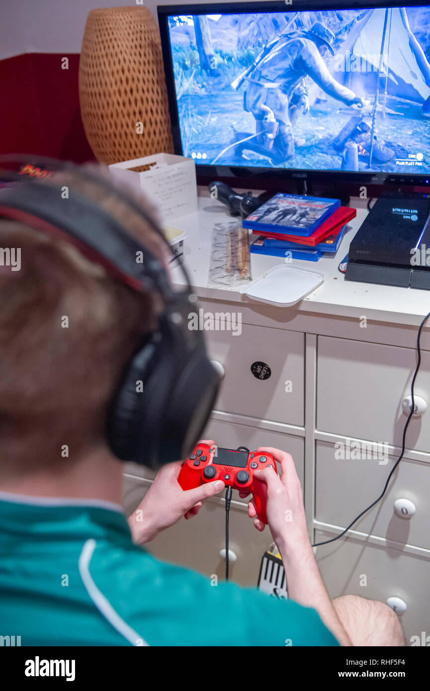 A teenaged boy playing computer games in his bedroom Stock Photo - Alamy