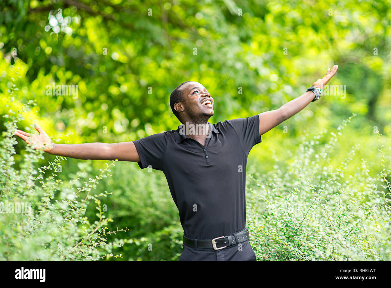 Freedom african man smiles happily in green nature Stock Photo - Alamy