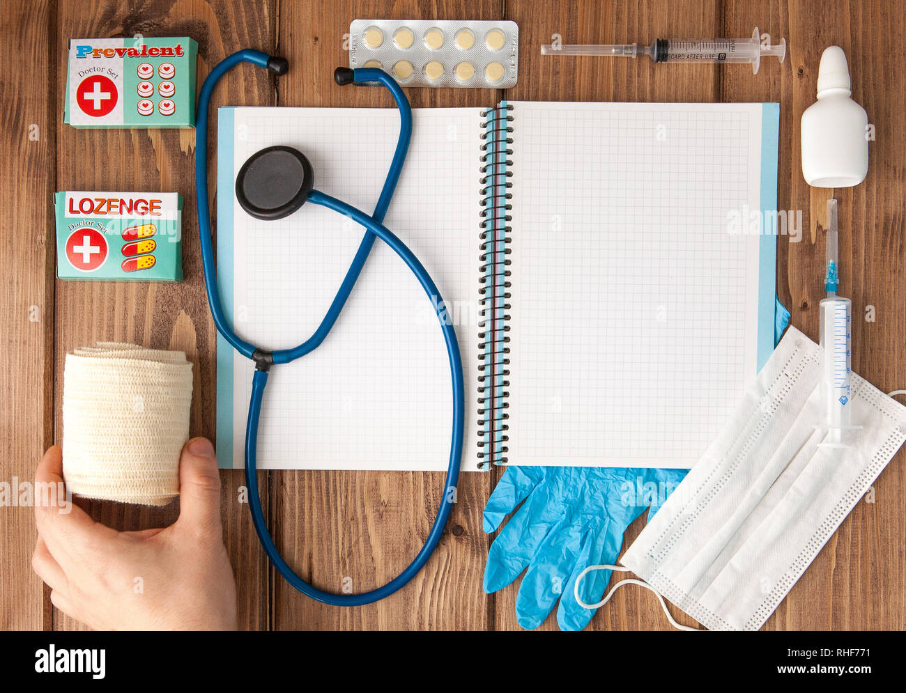 Syringe, stethoscope, blank page notepad, bandage, pill, elastic ...