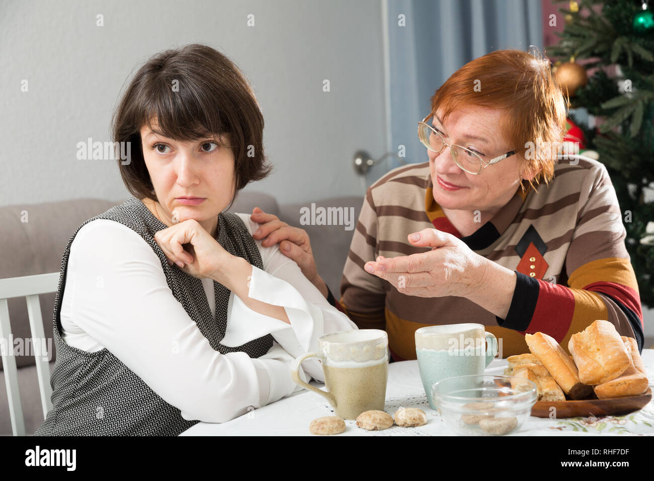 Quarrel of mother and daughter at the Christmas table Stock Photo - Alamy