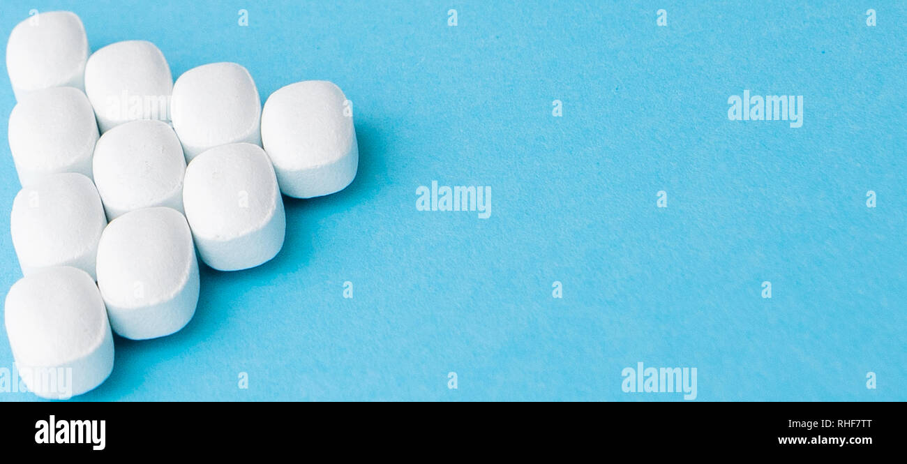 Assorted pharmaceutical medicine pills, tablets over blue background ...