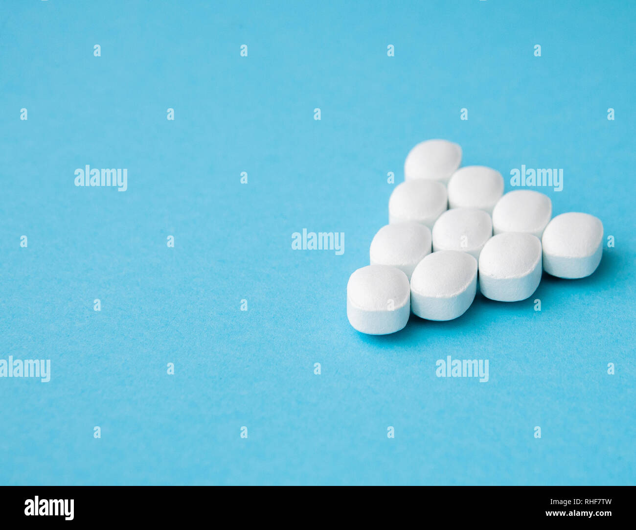 Assorted pharmaceutical medicine pills, tablets over blue background ...