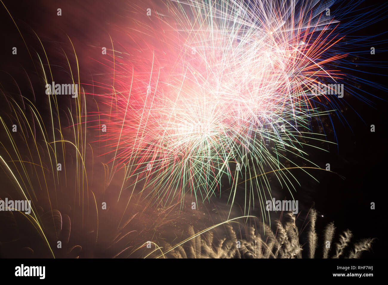 Colorful fireworks display on night sky background Stock Photo - Alamy