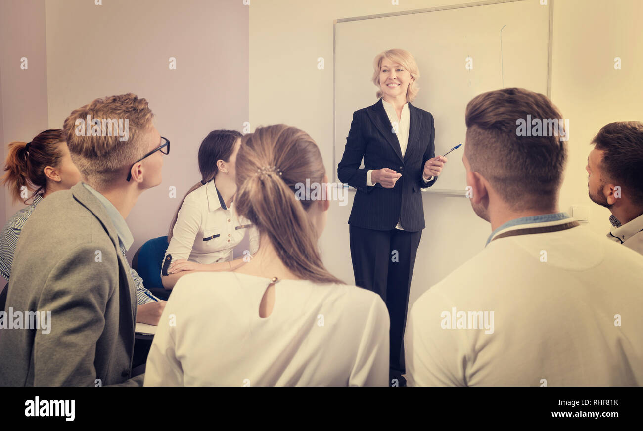 Elegant female teacher lecturing to the students at an auditorium Stock ...