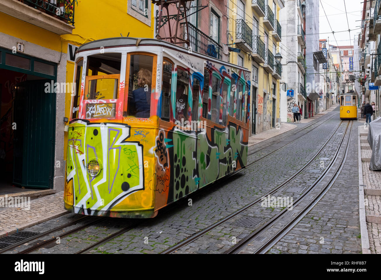 Traditional Brightly Coloured Lisbon Tram steep slope descent Stock ...