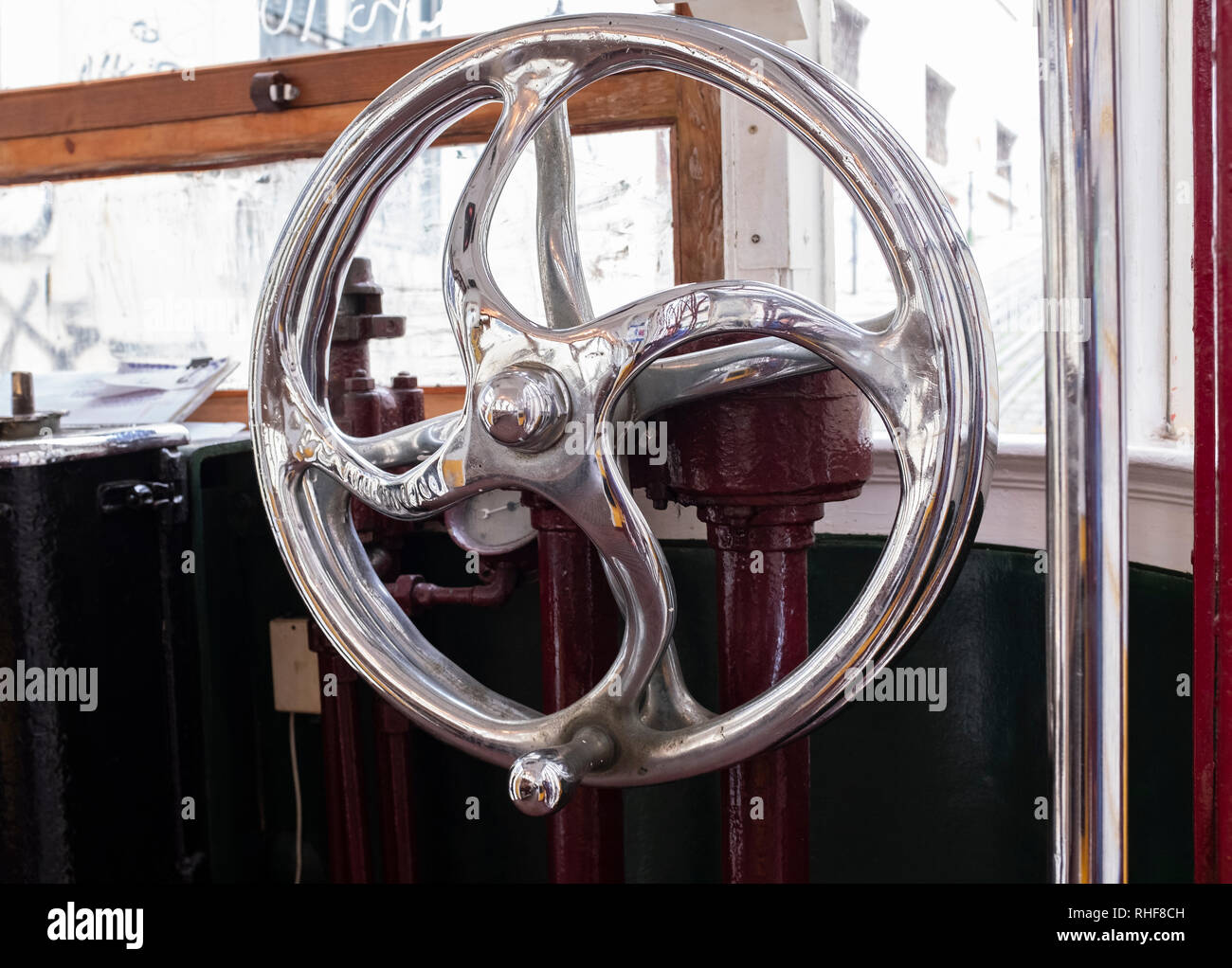 Highly polished chrome tram wheel in cabin of traditional Lisbon Tram ...