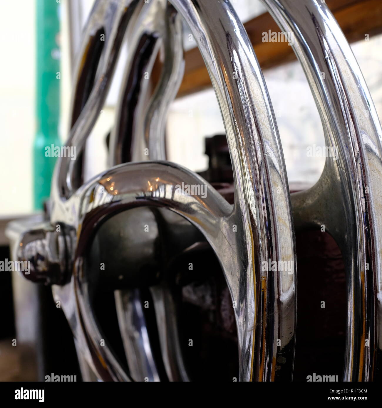 Highly polished chrome tram wheel in cabin of traditional Lisbon Tram ...