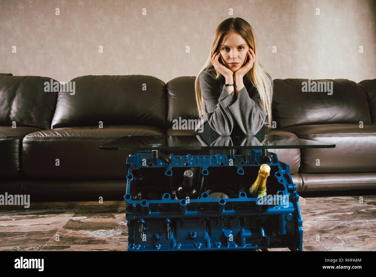 Young caucasian blonde girl sitting on sofa at luxury interior with ...