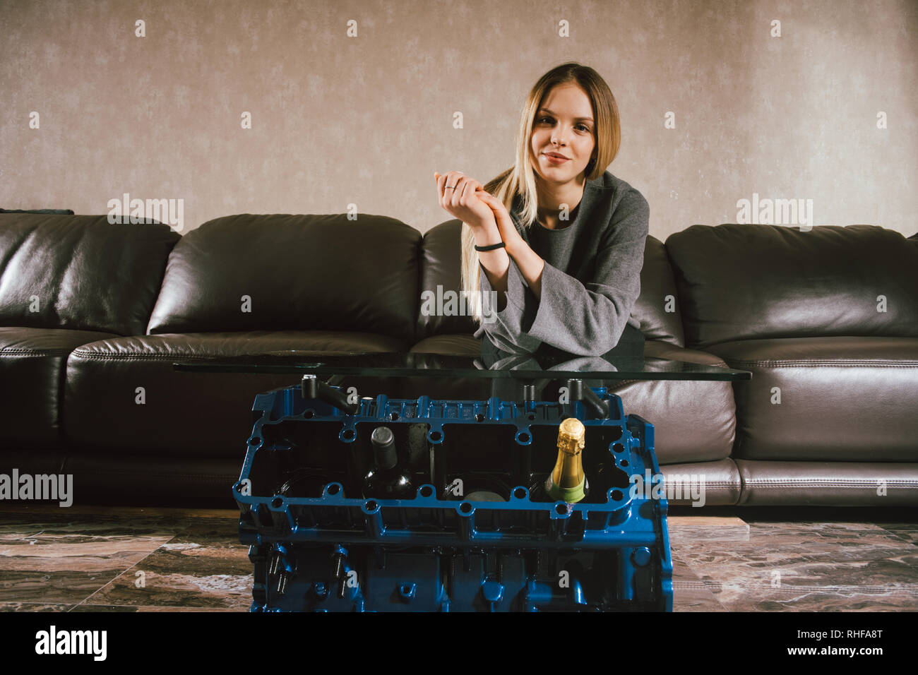 Young caucasian blonde girl sitting on sofa at luxury interior with ...