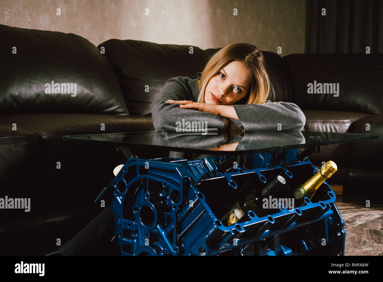 Young caucasian blonde girl sitting on sofa at luxury interior with ...