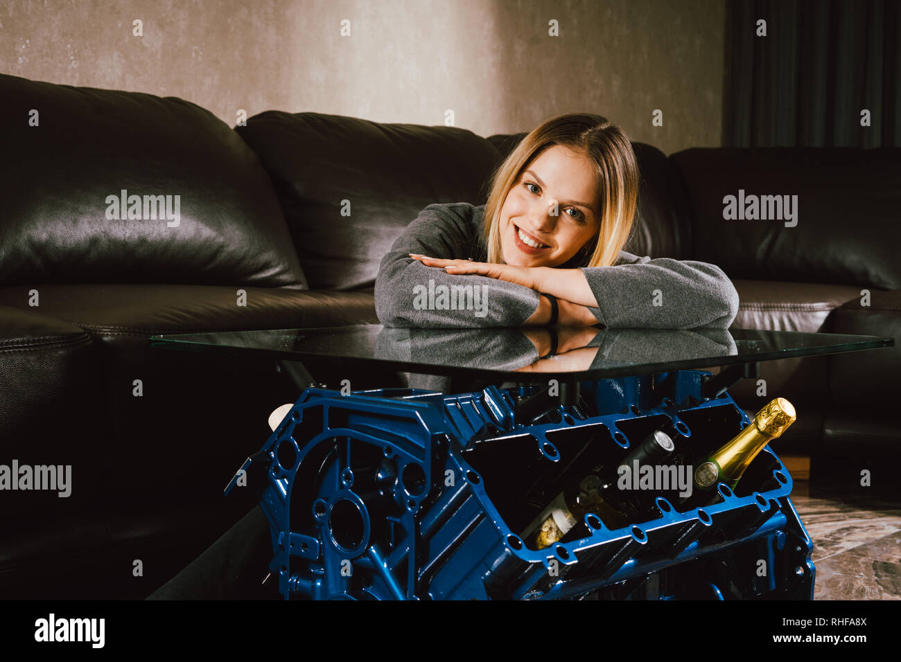 Young caucasian blonde girl sitting on sofa at luxury interior with ...