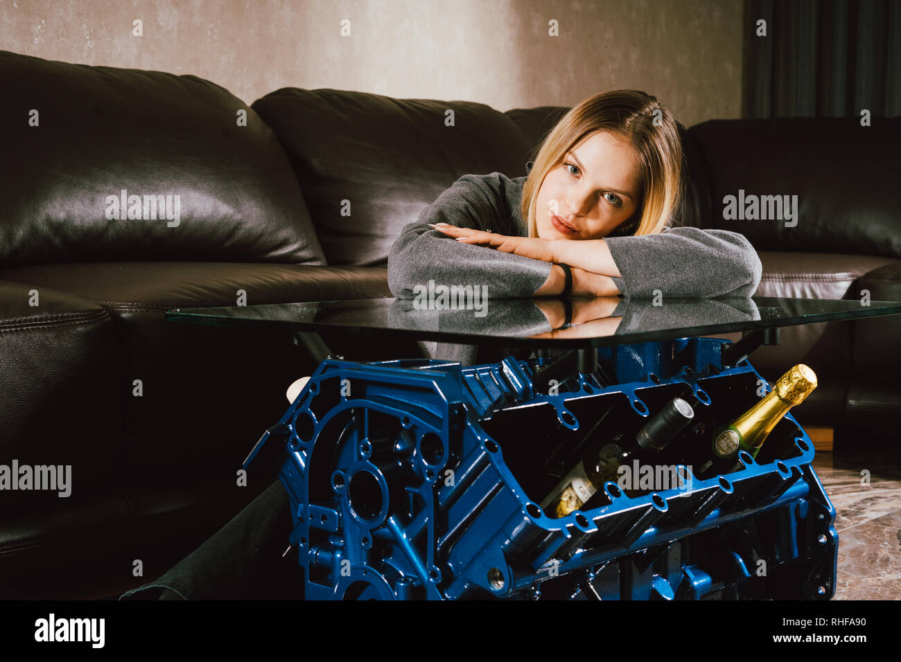 Young caucasian blonde girl sitting on sofa at luxury interior with ...