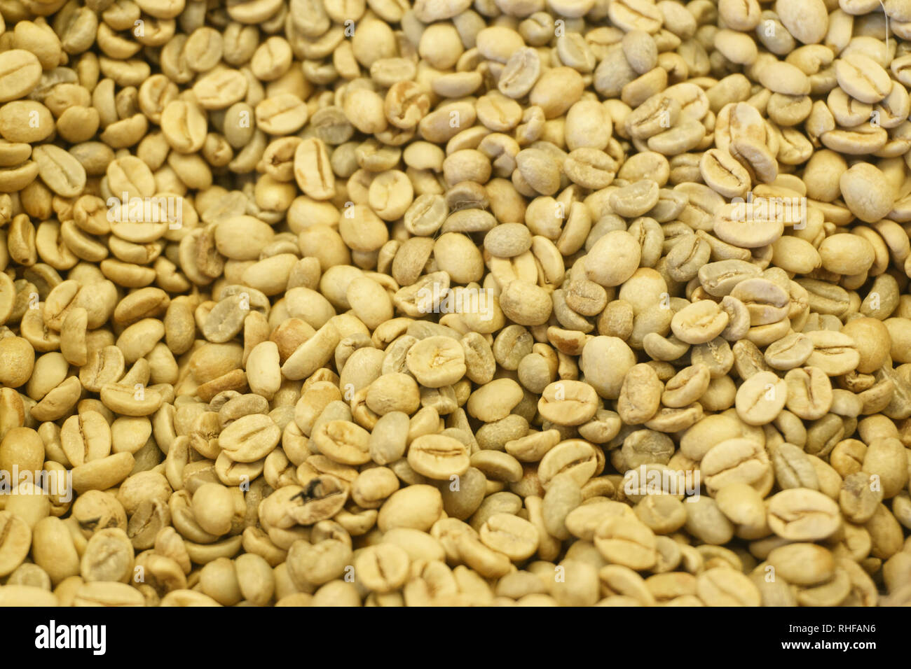 Raw coffee bean for background Stock Photo - Alamy