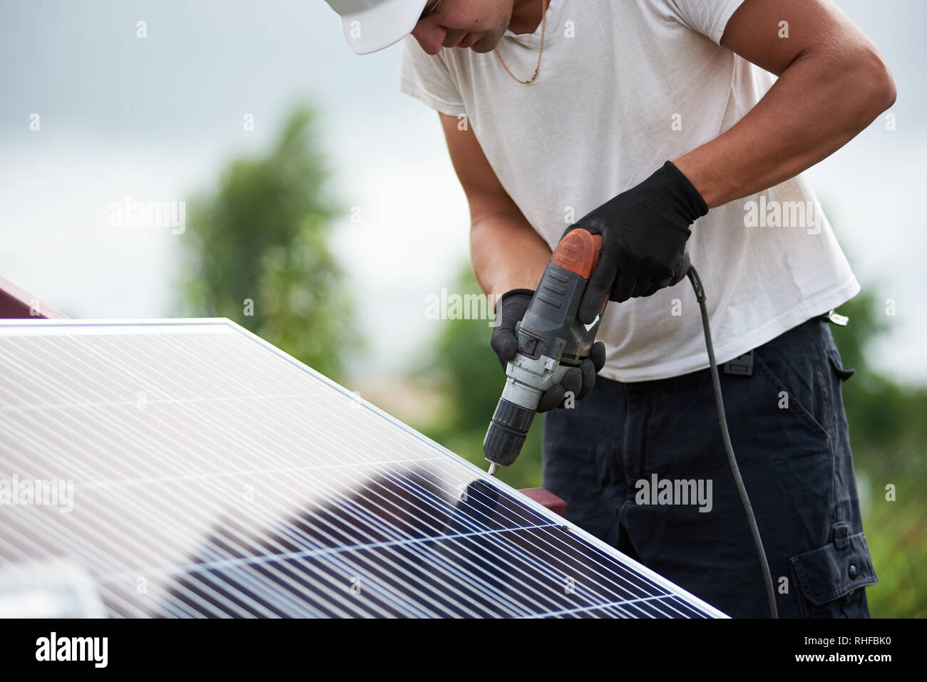 Technician worker assembling shiny solar photo voltaic panels using ...