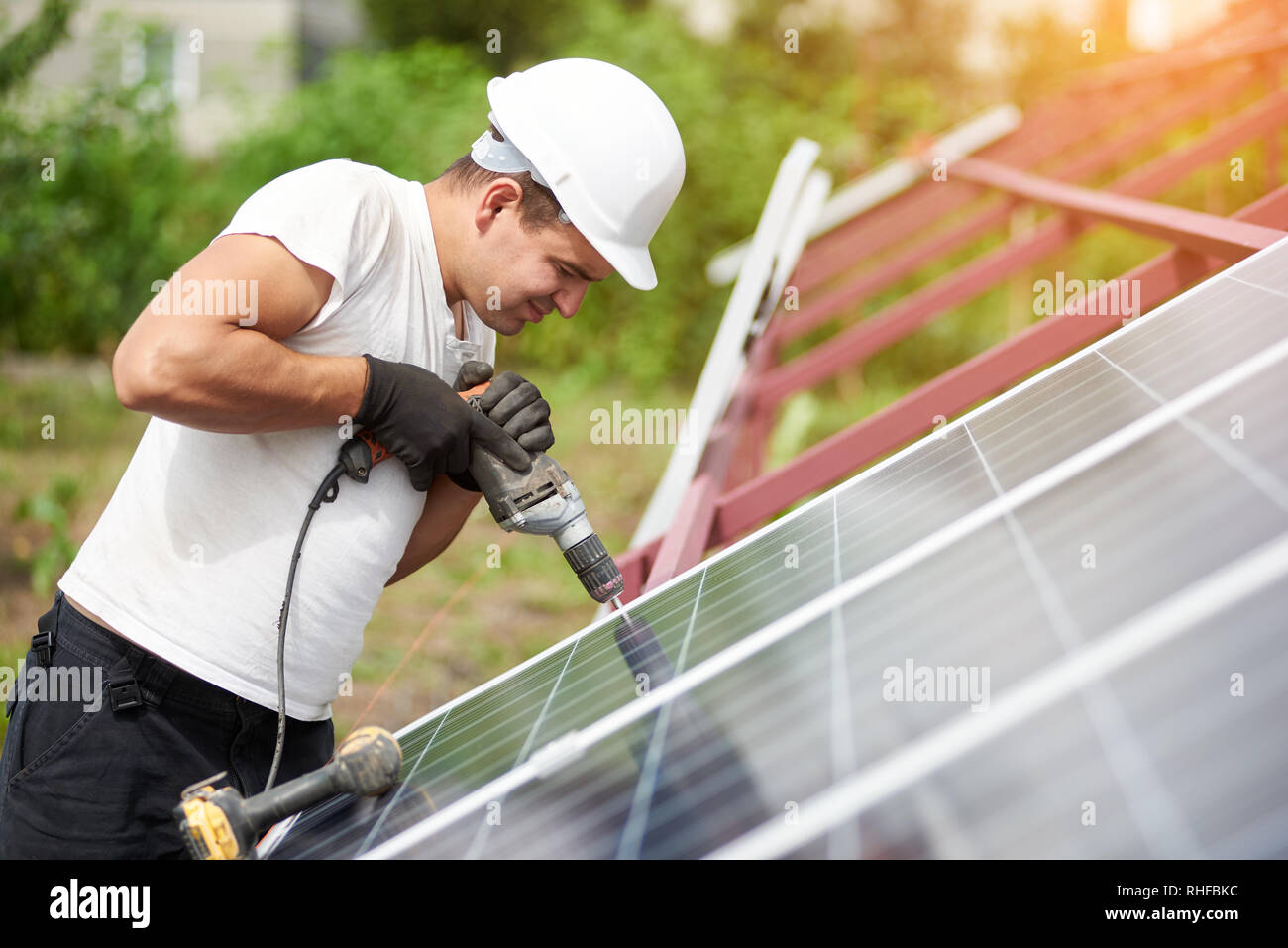 Profile view of technician connecting blue shiny solar photo voltaic ...