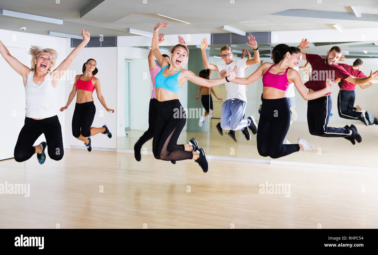 Sporty different ages adults jumping at dance class Stock Photo - Alamy