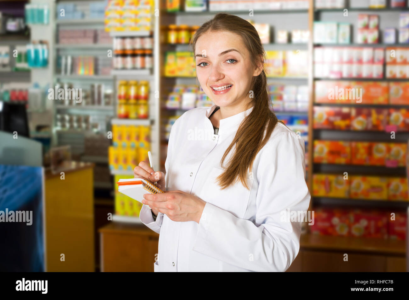 Portrait of beautiful female pharmacist working in modern farmacy Stock ...