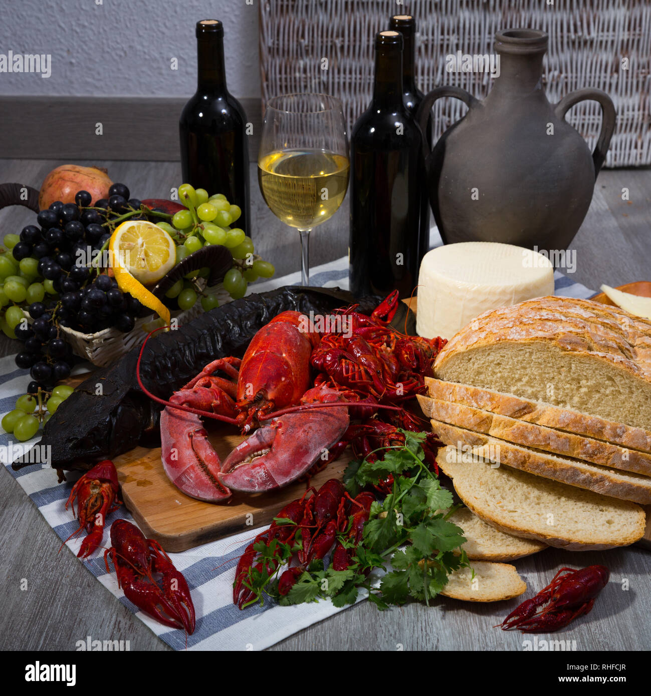 Delicious crustaceans with smoked sturgeon and white wine on wooden ...