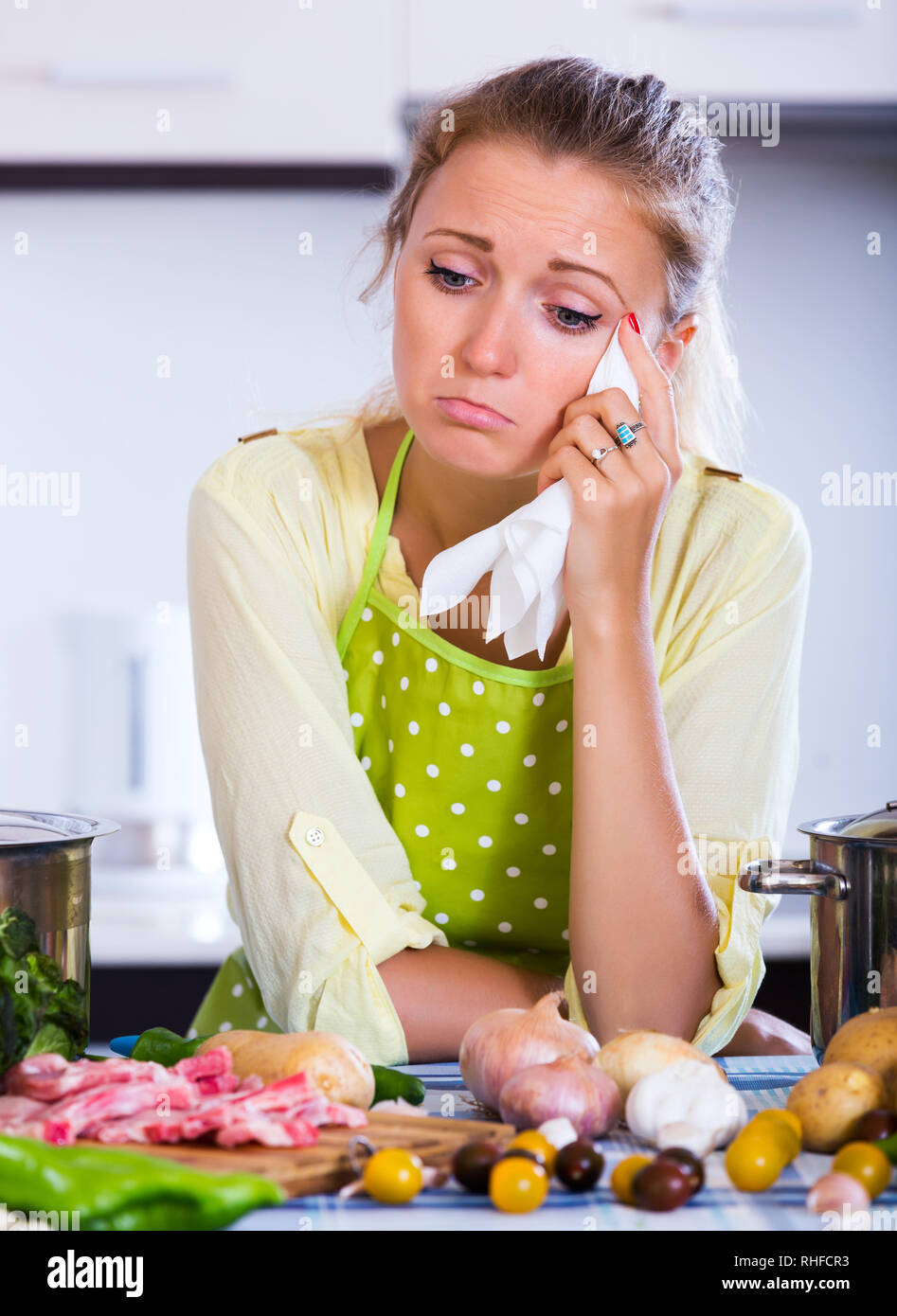 Frustrated young girl looking at dinner ingredients with sad face Stock ...