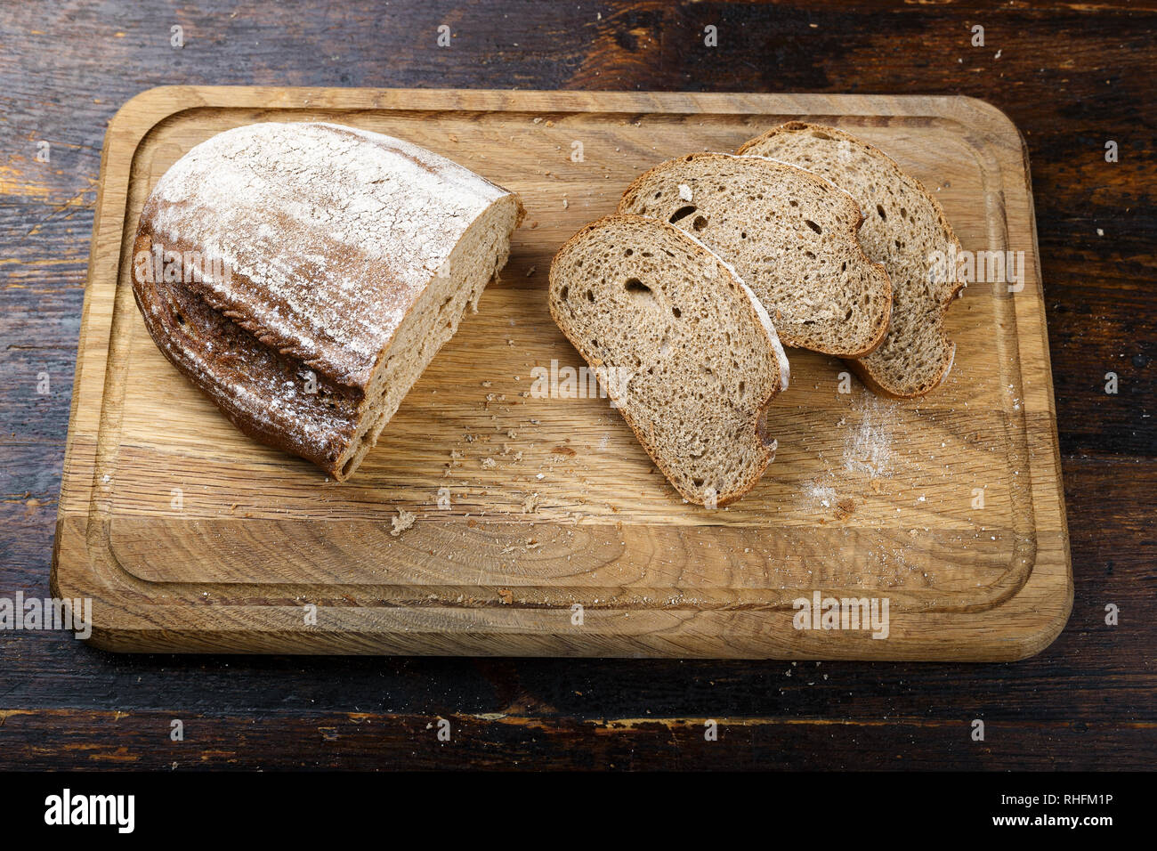 Sliced homemade black bread close-up on a wooden background. space for ...