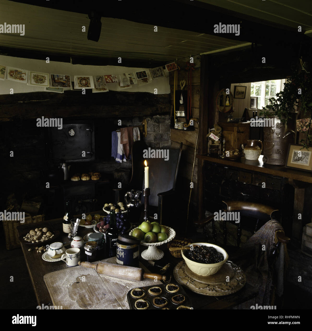 Old fashioned kitchen with one candle for light Stock Photo - Alamy