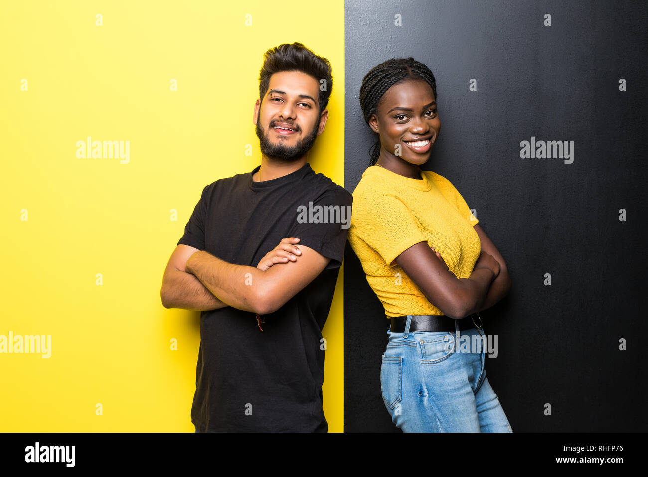 Young mixed race couple, indian man and african woman standing back to ...