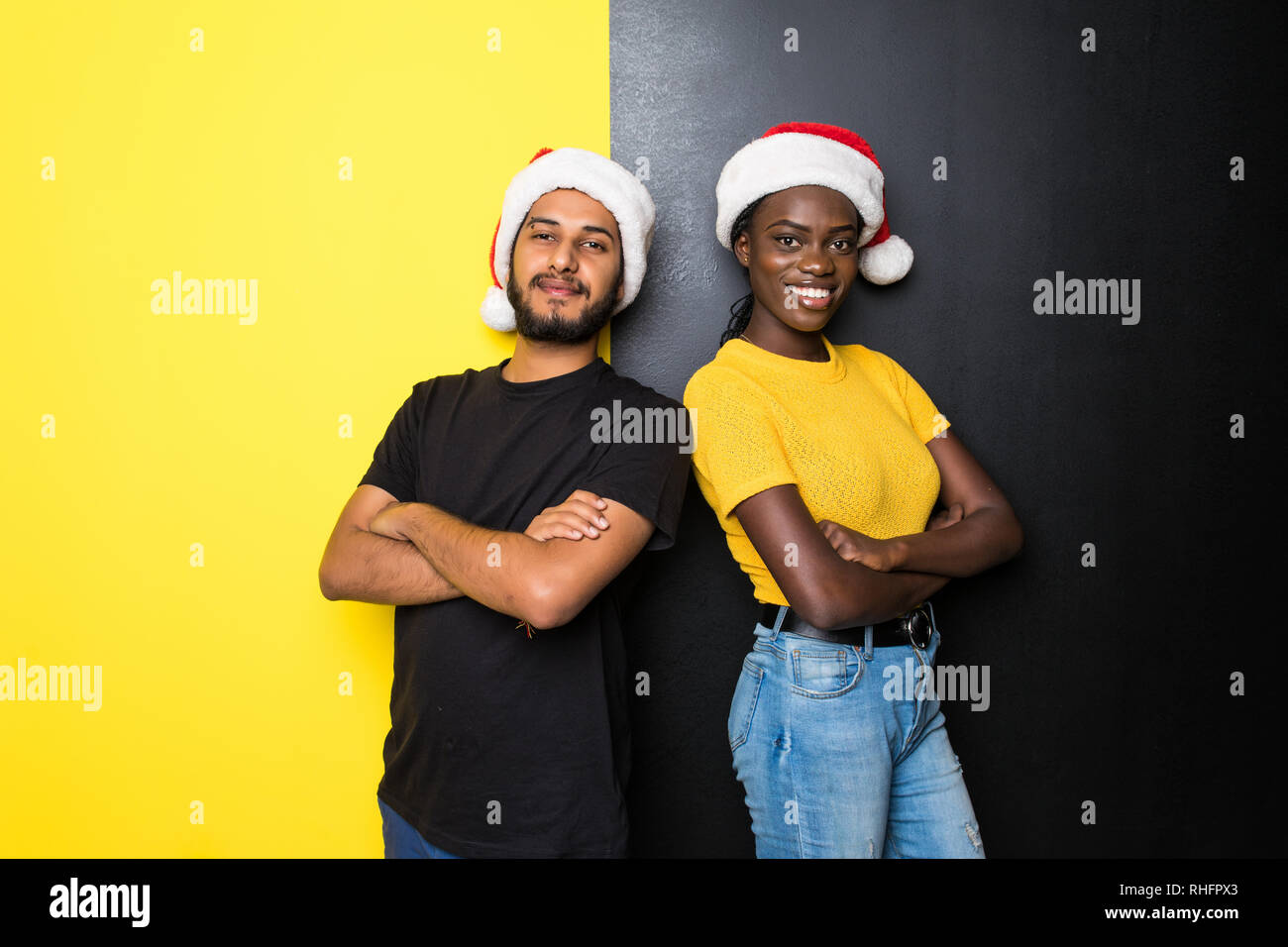 Young happy mixed race couple, indian man and african woman in santa ...