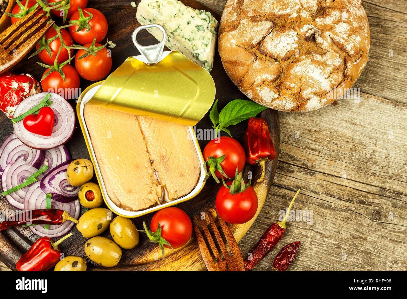 Canned tuna on a kitchen table. Fish cans and vegetables. Food for ...