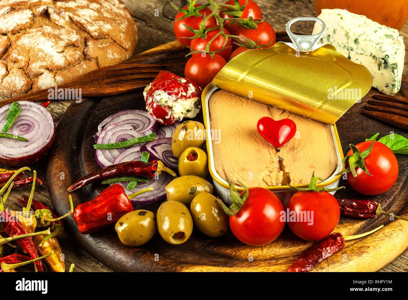 Canned tuna on a kitchen table. Fish cans and vegetables. Food for ...