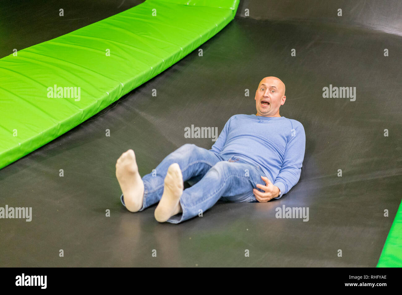 The man on a trampoline. The man fell on a trampoline. Man first time ...